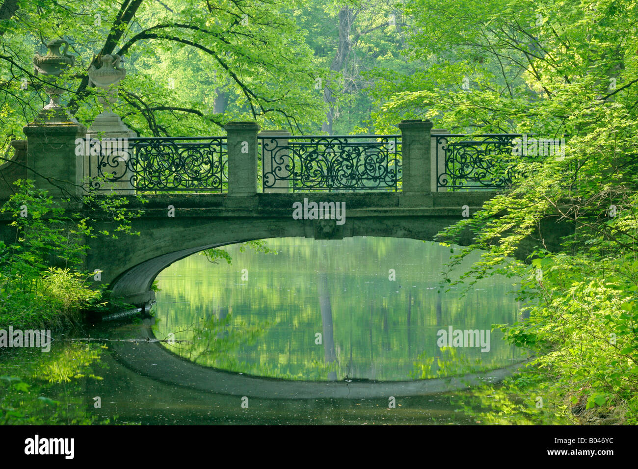 Romantic bridge in baroque style built bridge reflecting in brook in ...