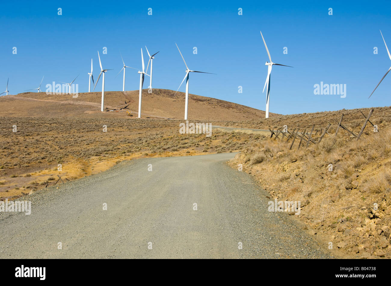Road leading to a wind farm in the desert Stock Photo - Alamy