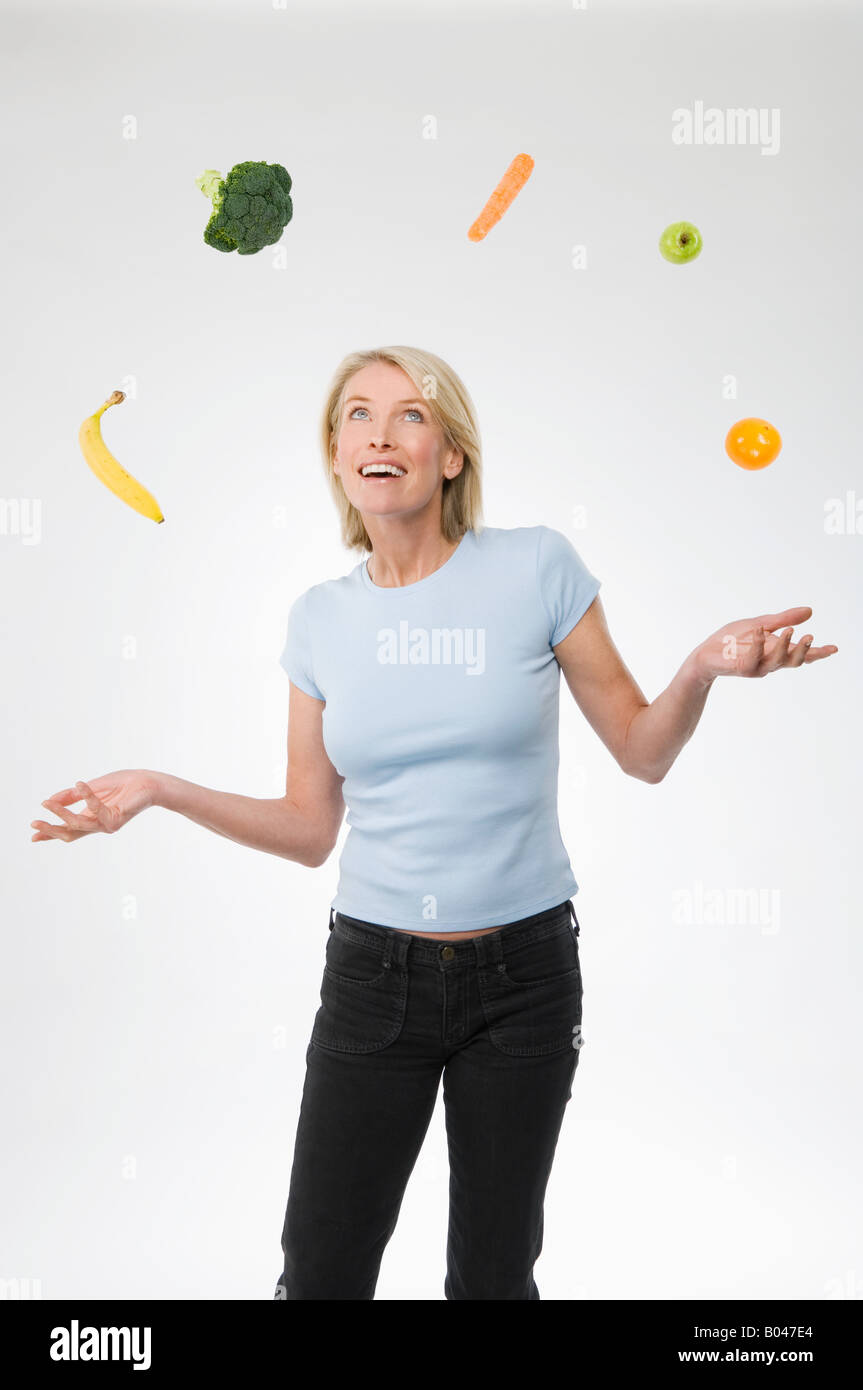 A woman juggling fruit and vegetables Stock Photo - Alamy