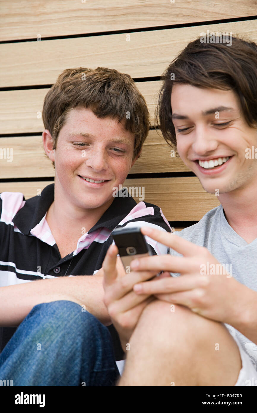 Teenage boys using a cell phone Stock Photo - Alamy