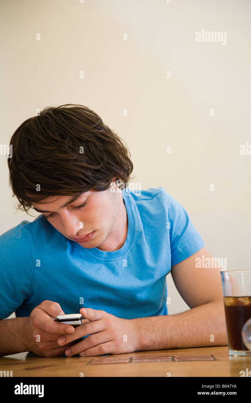 A teenage boy using a cell phone Stock Photo - Alamy