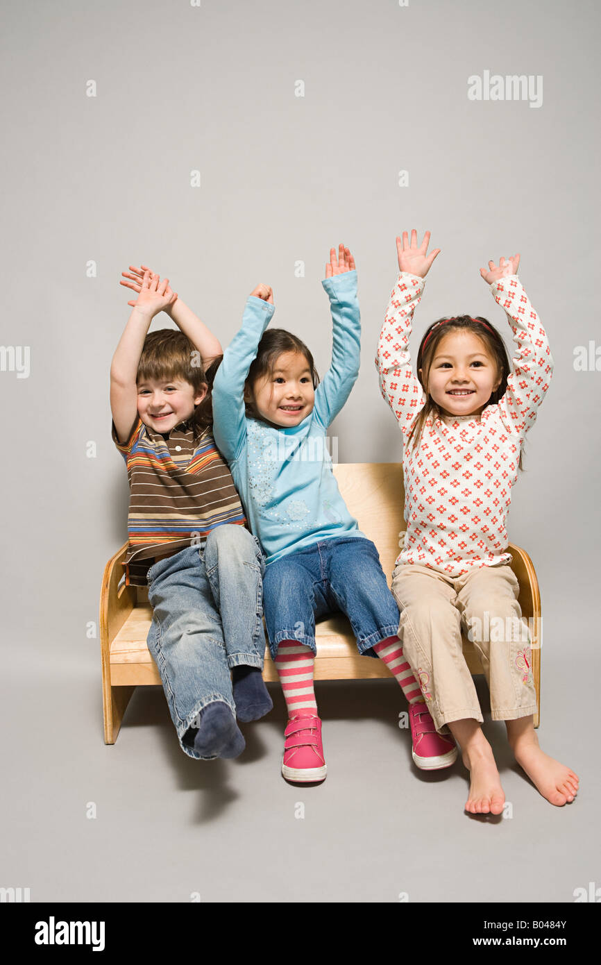 Children with their arms raised Stock Photo - Alamy