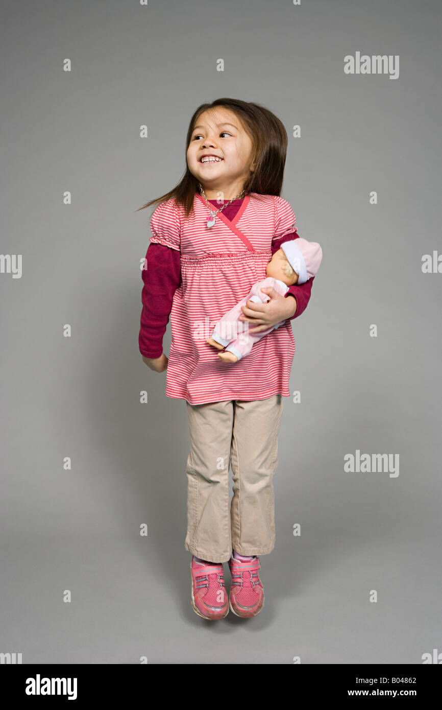 Child holding a doll hi-res stock photography and images - Alamy