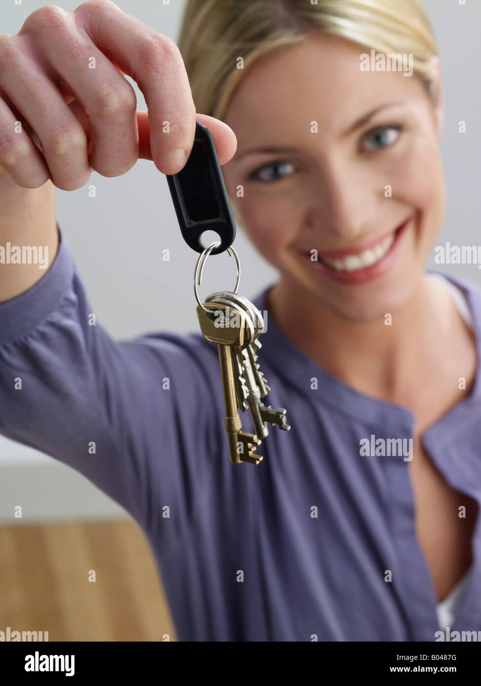 A woman holding keys Stock Photo - Alamy
