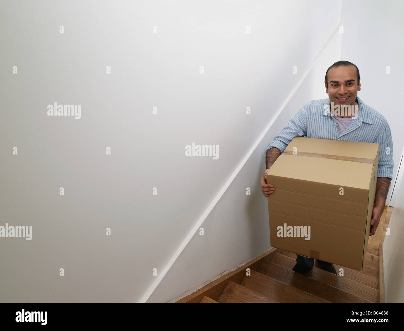 A man carrying a box Stock Photo - Alamy