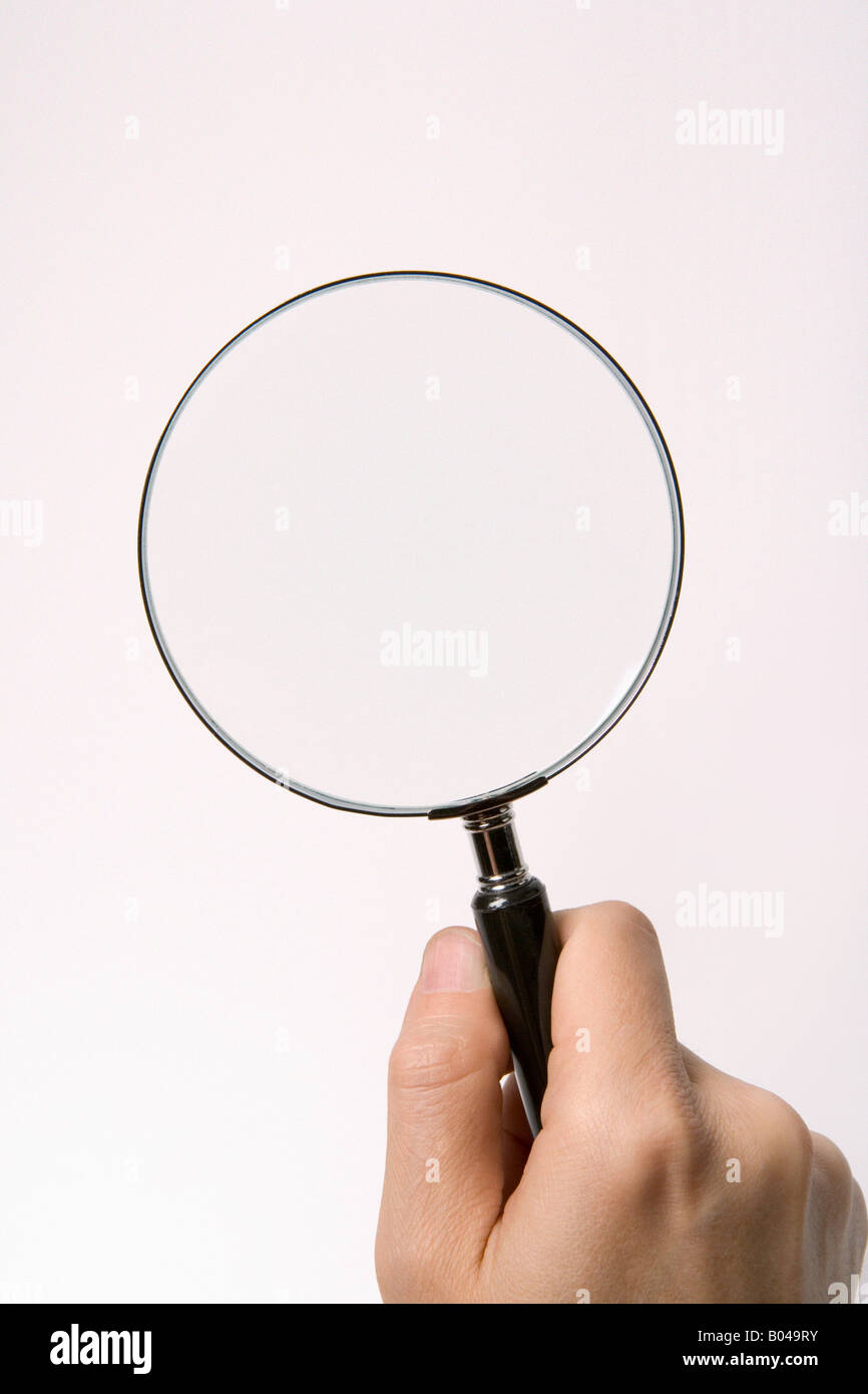 Person with magnifying glass Stock Photo - Alamy