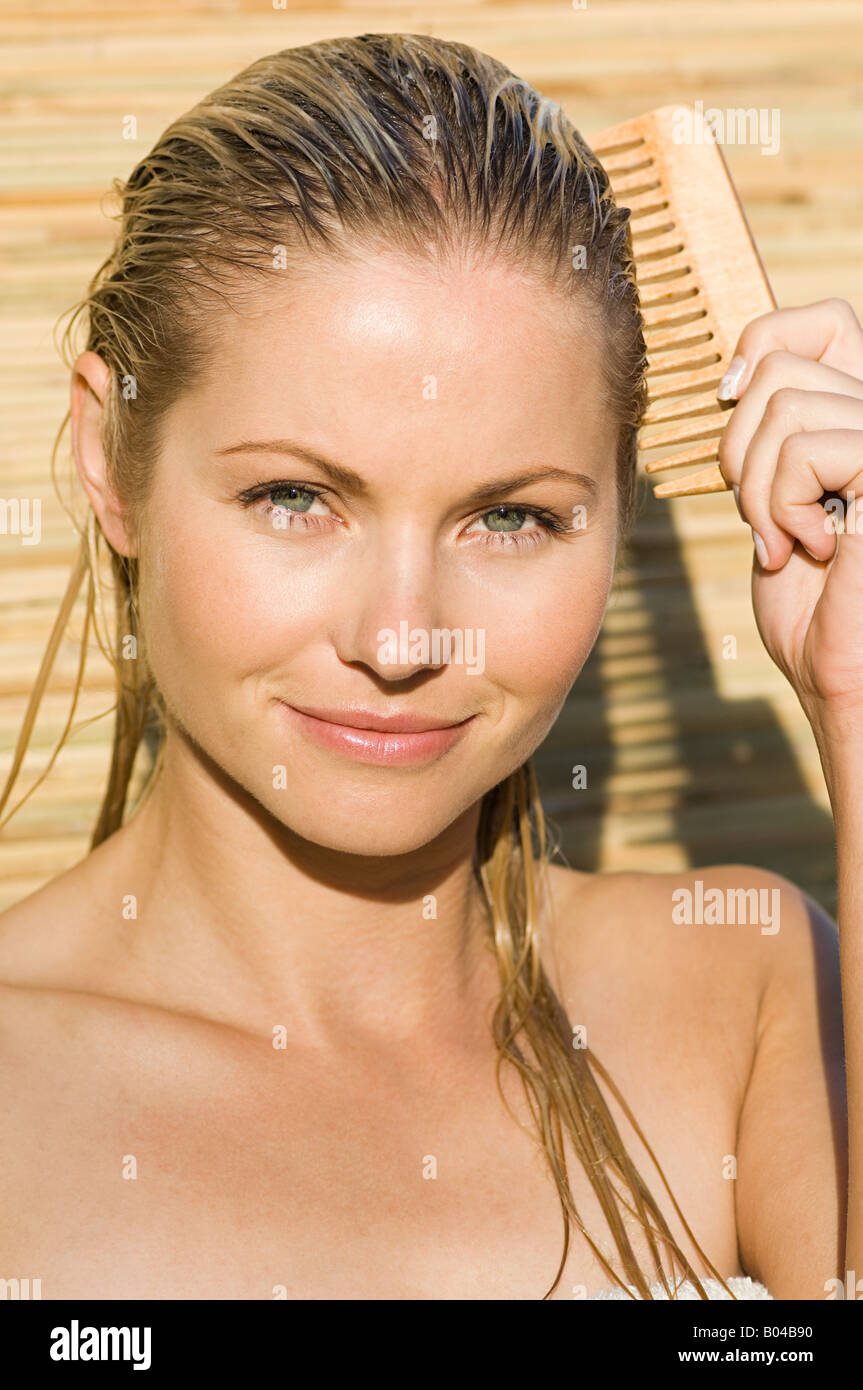 Portrait of a woman combing her hair hi-res stock photography and ...