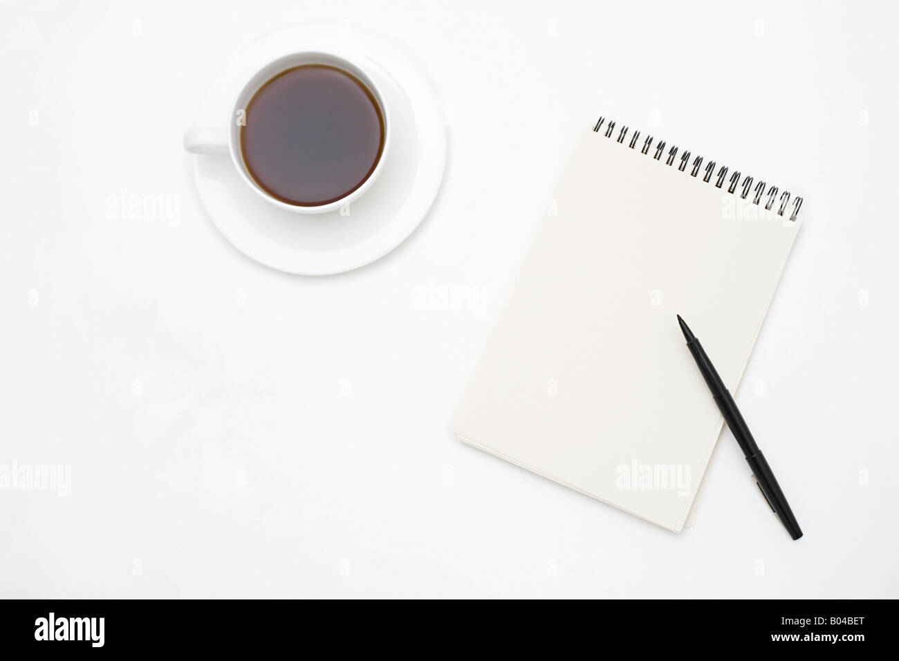 Notepad and coffee cup Stock Photo - Alamy