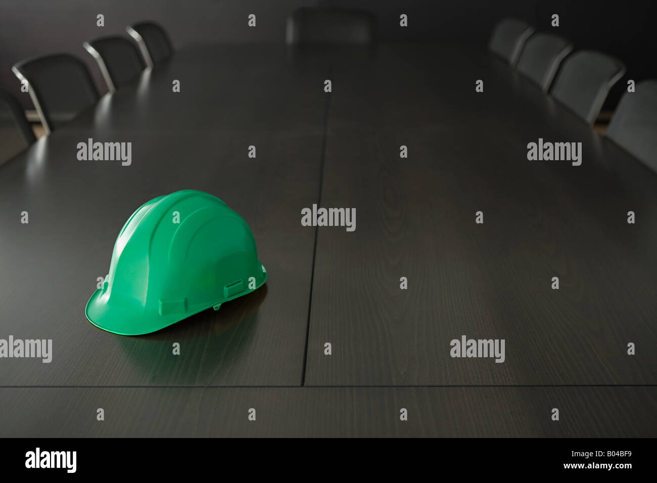 Hard hat on a conference table Stock Photo - Alamy