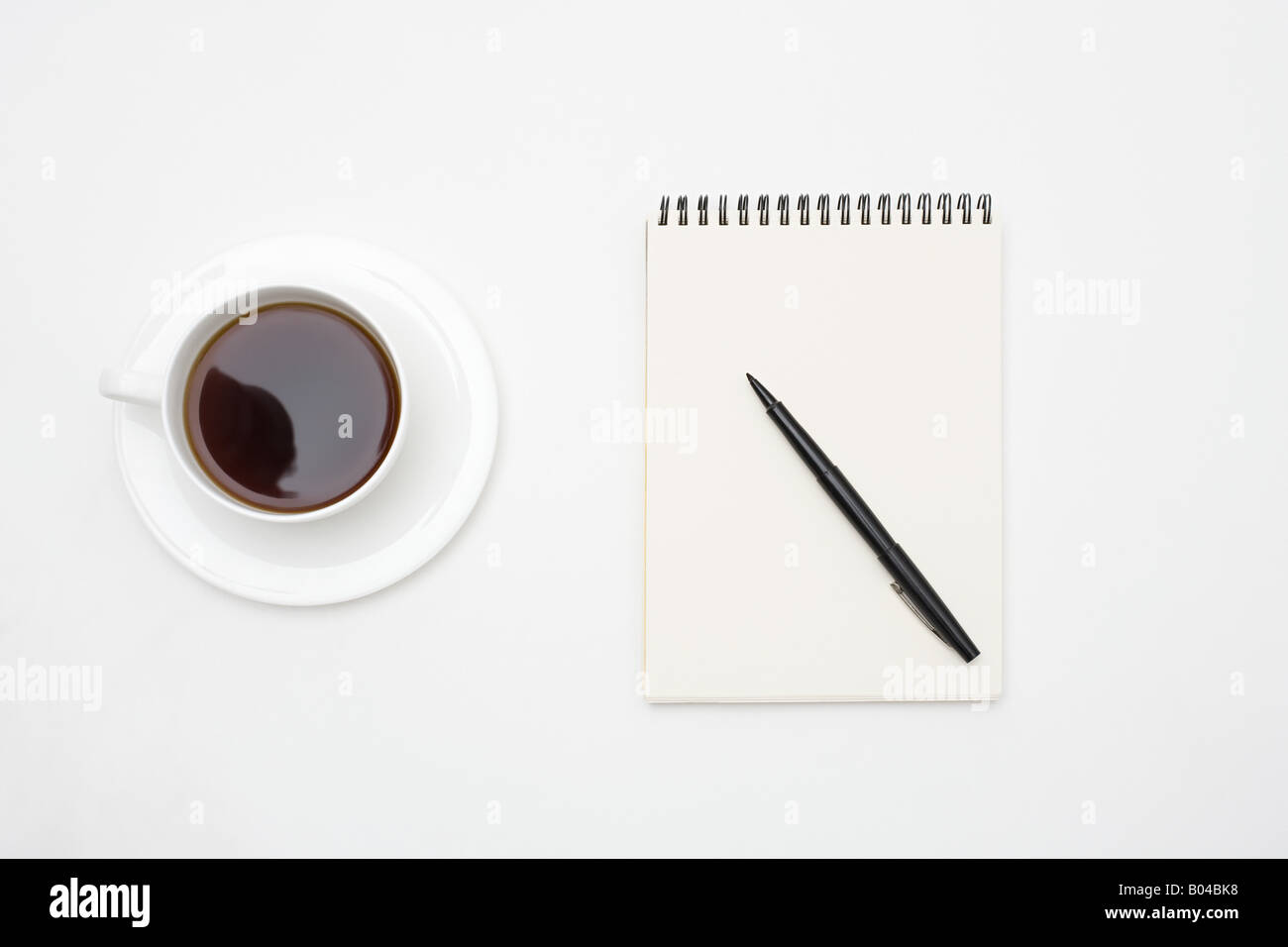 Notepad and coffee cup Stock Photo - Alamy