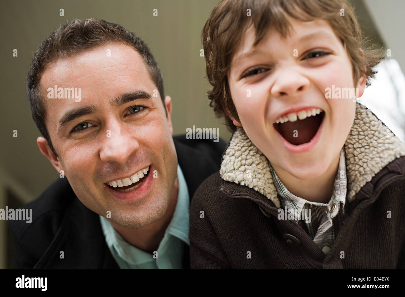 Portrait of a father and son laughing Stock Photo - Alamy