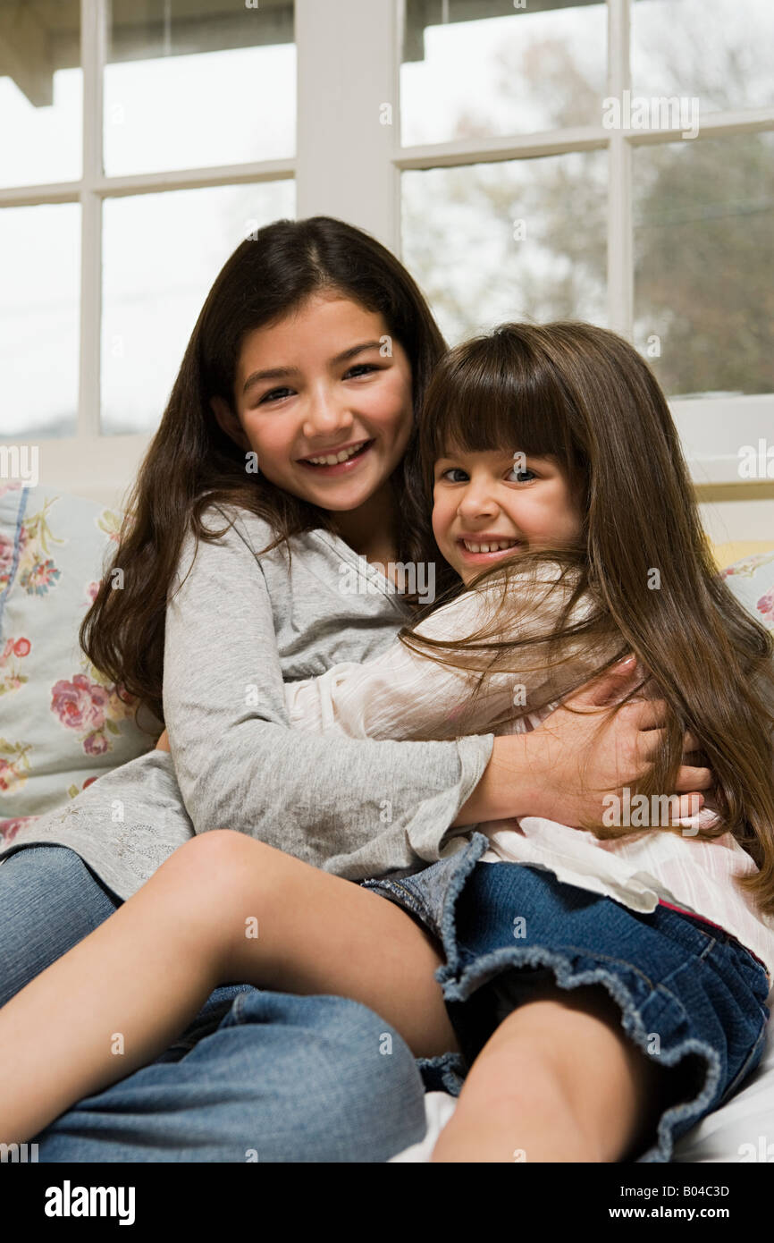 Sisters hugging Stock Photo - Alamy