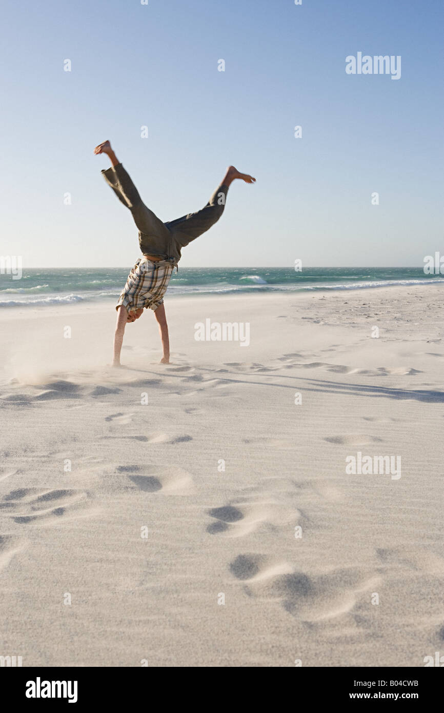 A young man doing a handstand Stock Photo - Alamy