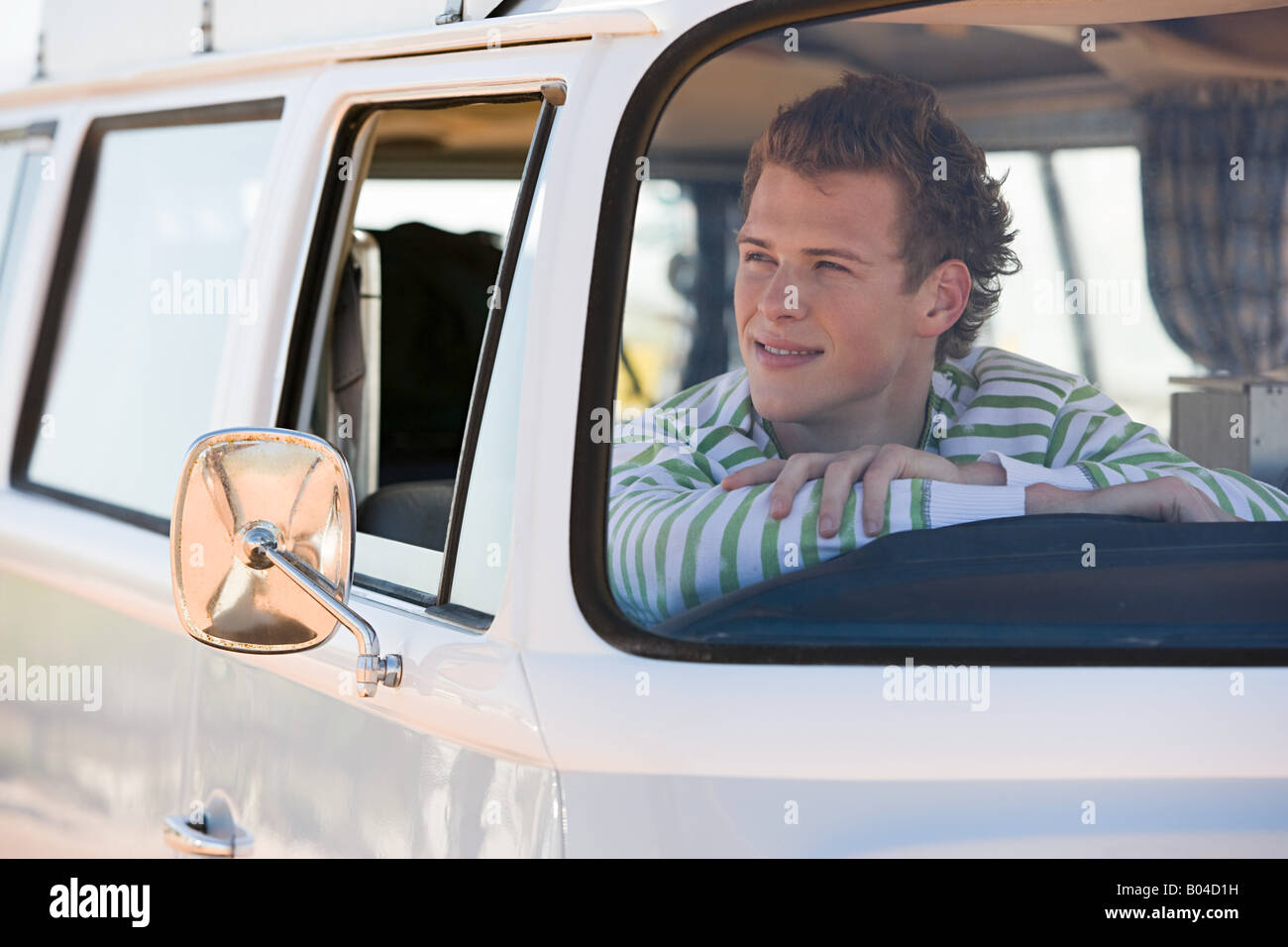 A young man in a camper van Stock Photo - Alamy