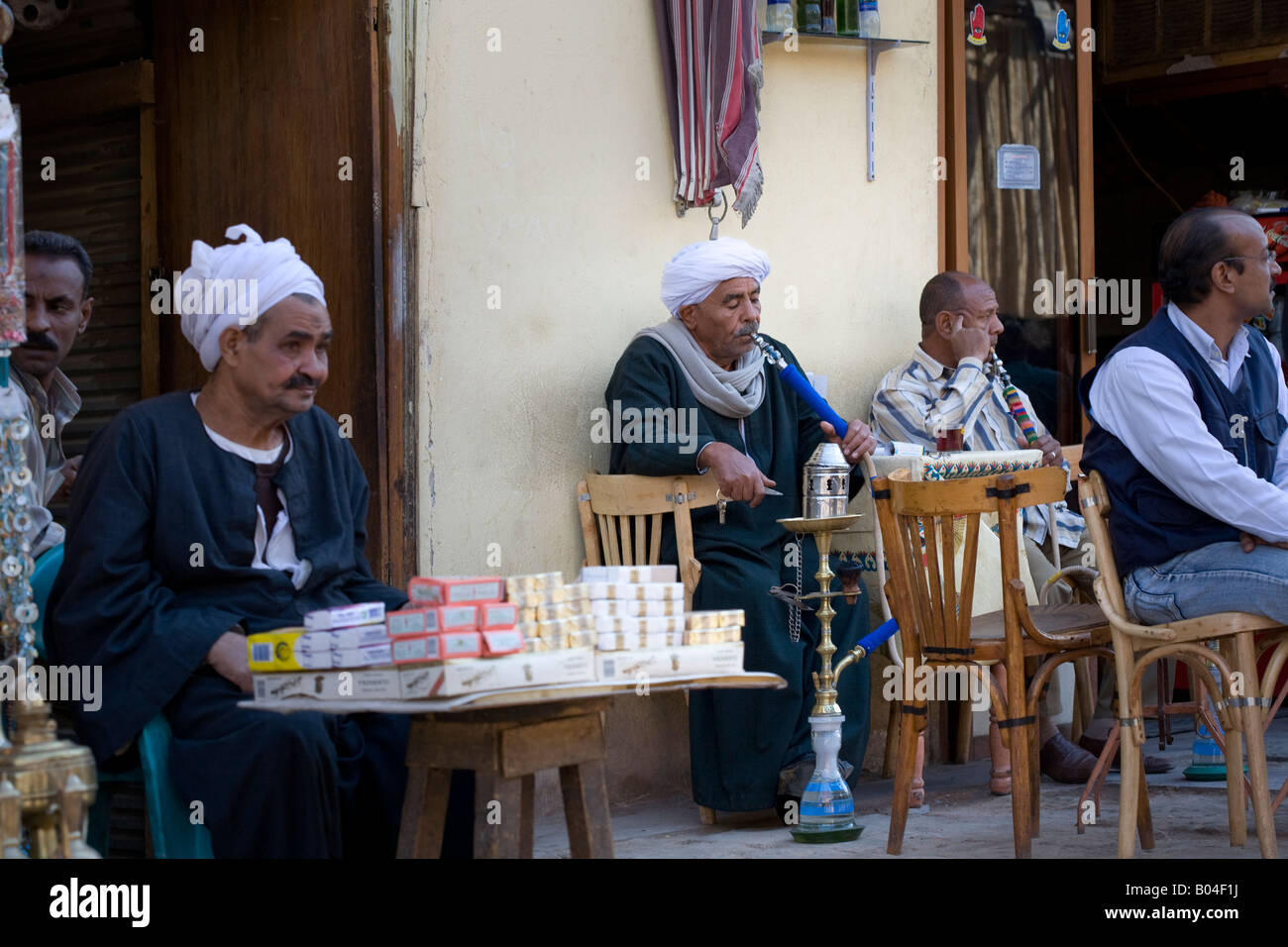 Tobacco salesman and shisha smoker outside cafe in the souk Aswan ...