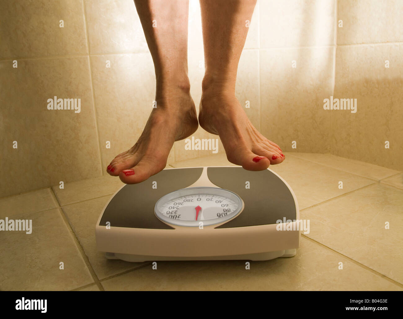 woman floating above bathroom scale Stock Photo - Alamy
