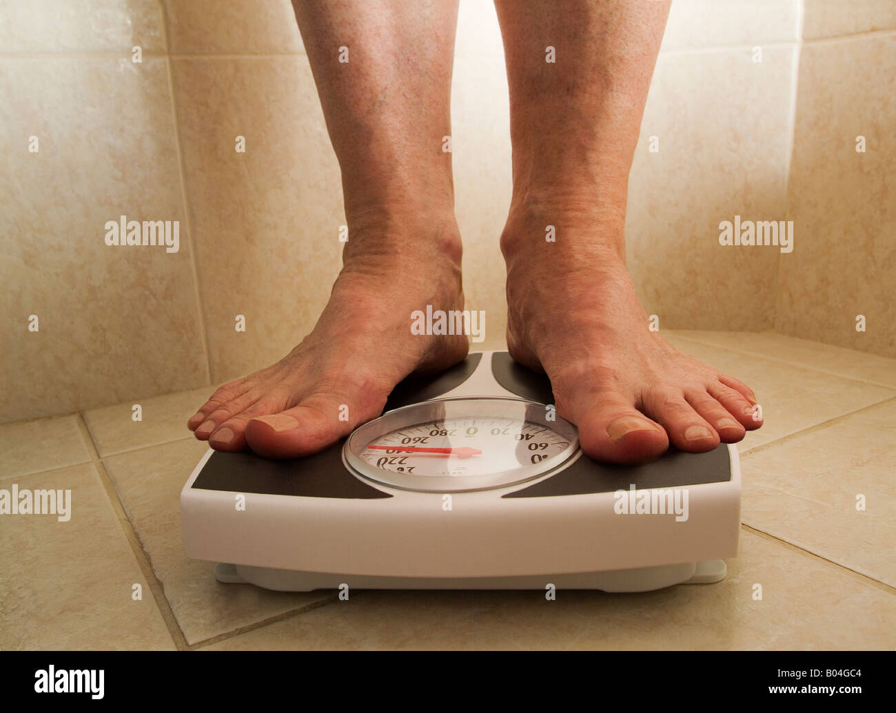overweight person on scale Stock Photo - Alamy