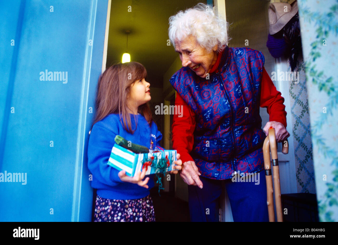 Giving Harvest Box To Elderly Lady Food For Needy Stock Photo - Alamy