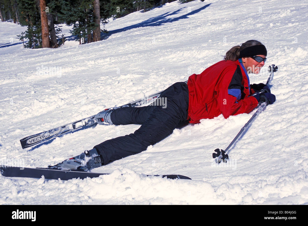Woman proves that falls come softly on spring snow Stock Photo - Alamy
