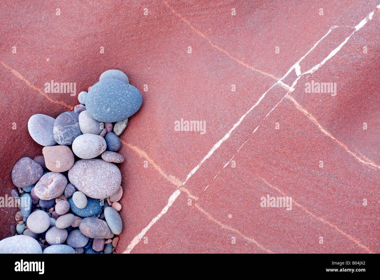 Pebbles lying on lower old red sandstone Stock Photo - Alamy