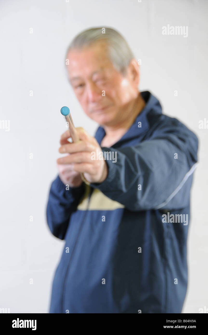 senior asian man checking on the cue stick Stock Photo - Alamy