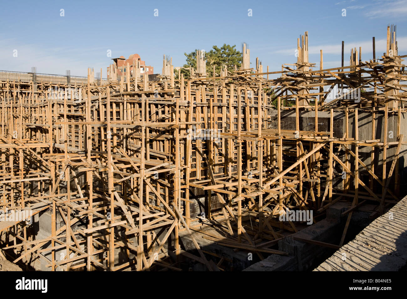 Modern building work in Aswan using tradional wooden scaffolding. Egypt ...