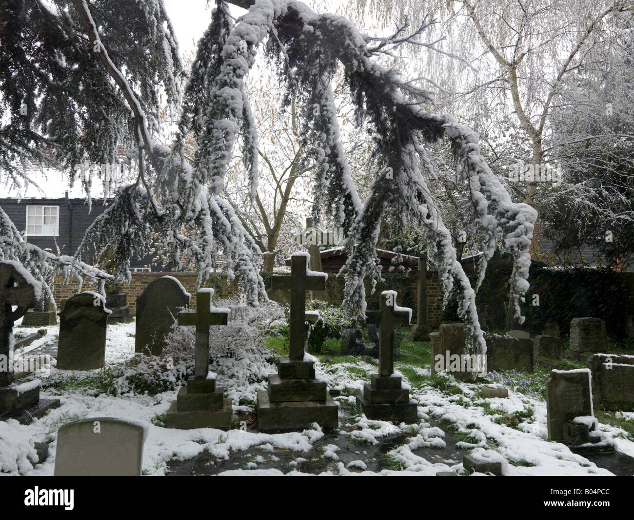 Graveyard in the Winter Falling Snow Stock Photo - Alamy