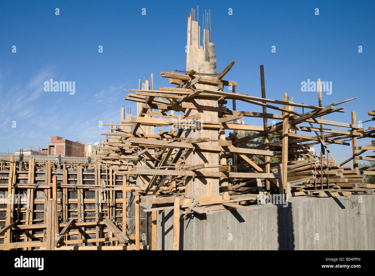Modern building work in Aswan using tradional wooden scaffolding. Egypt ...