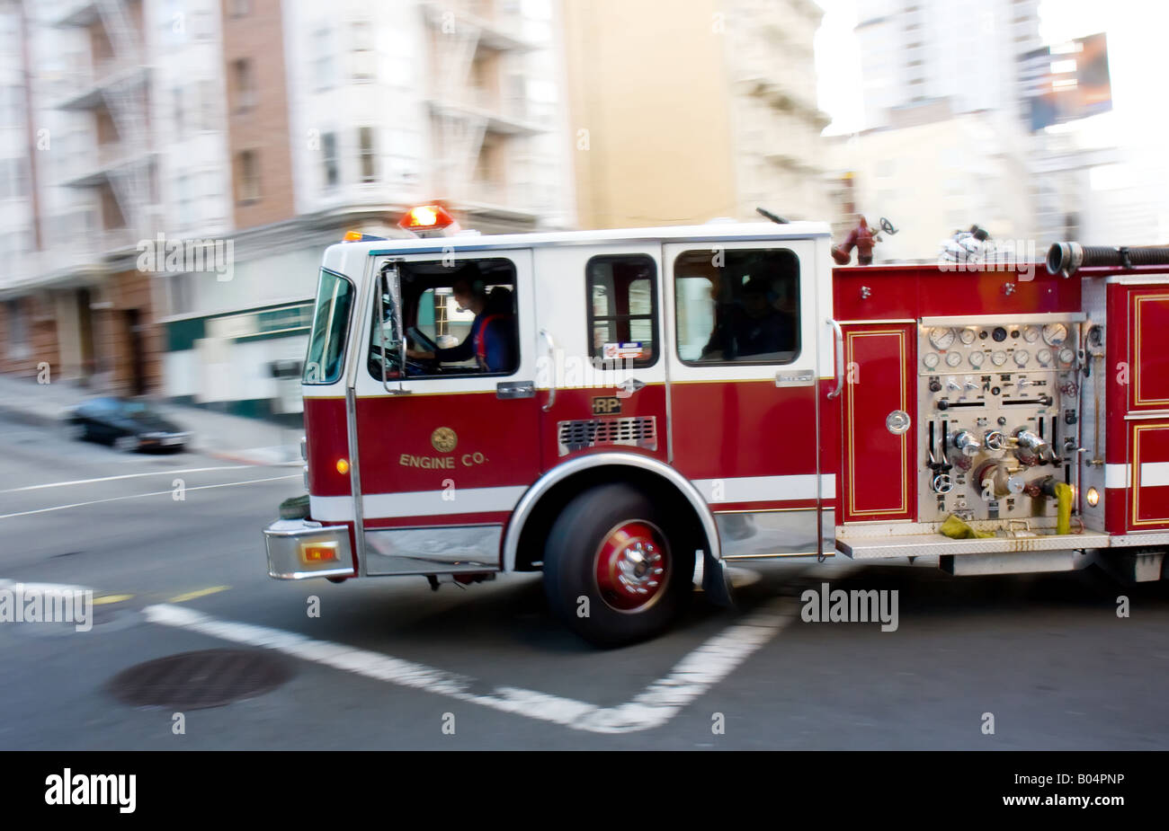 Fire engine in a big city on it's way to an emergency call with sirens ...