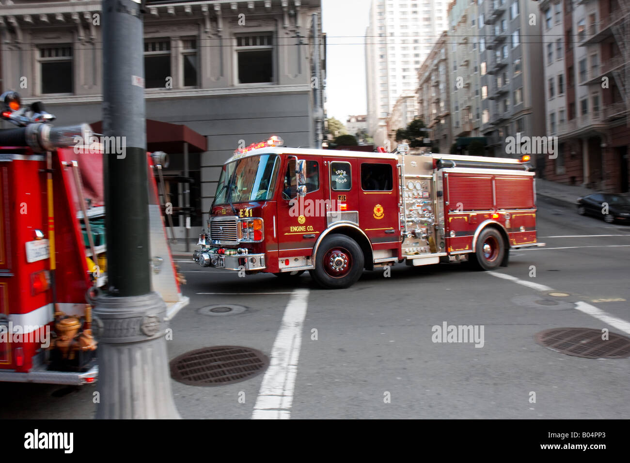 Fire engine in a big city racing to an emergency Stock Photo - Alamy
