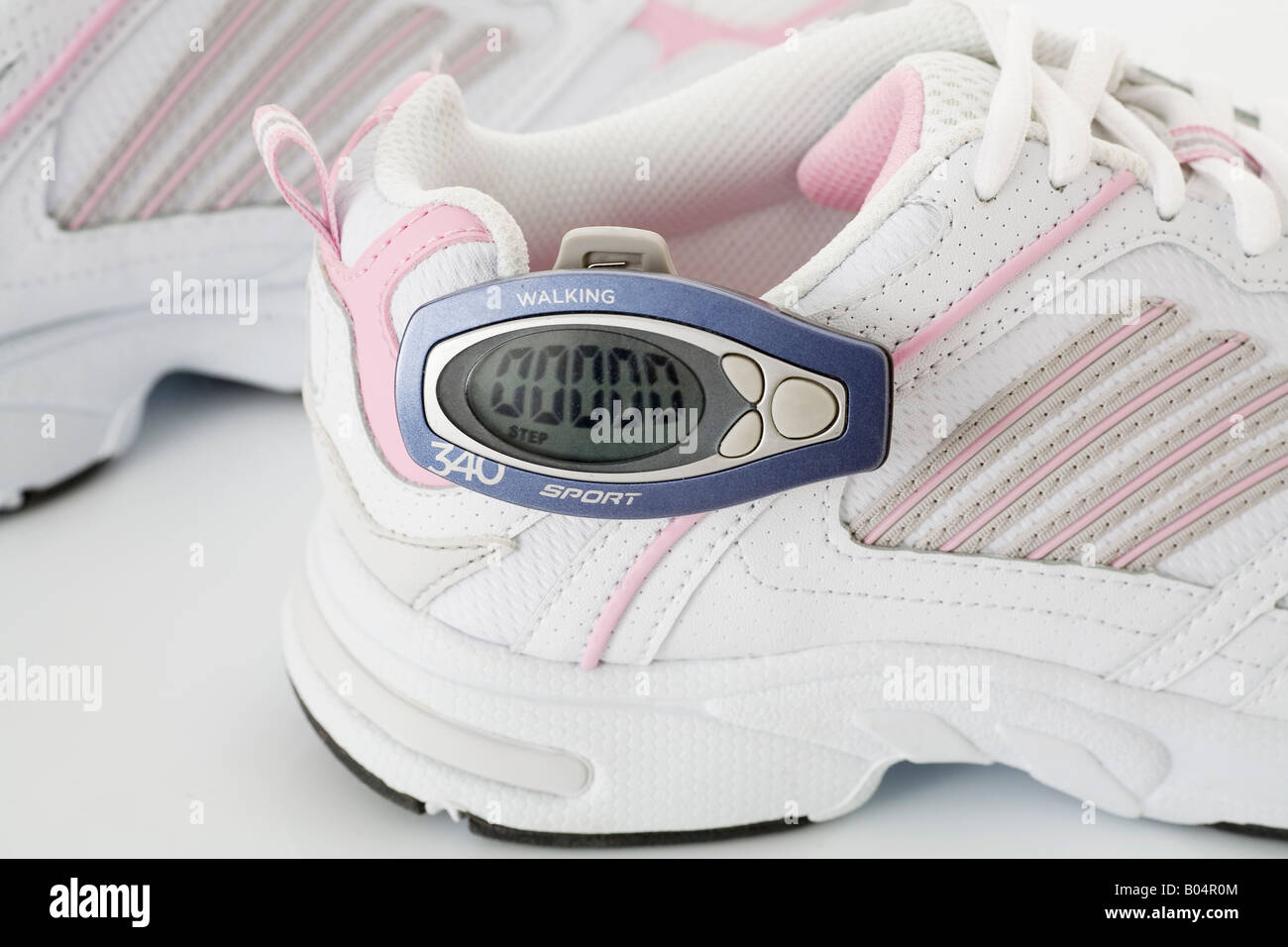 Pedometer clipped onto sneakers Stock Photo - Alamy