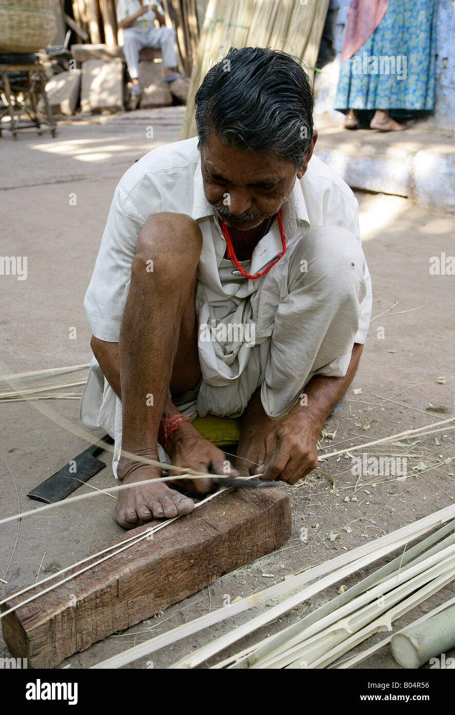 Man splitting bamboo for basket weaving Stock Photo - Alamy