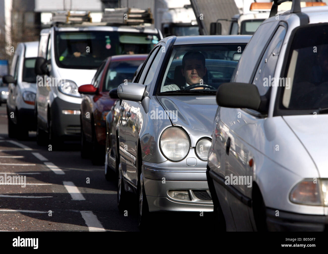 Cars waits wait in a traffic jam queue at traffic lights Stock Photo ...