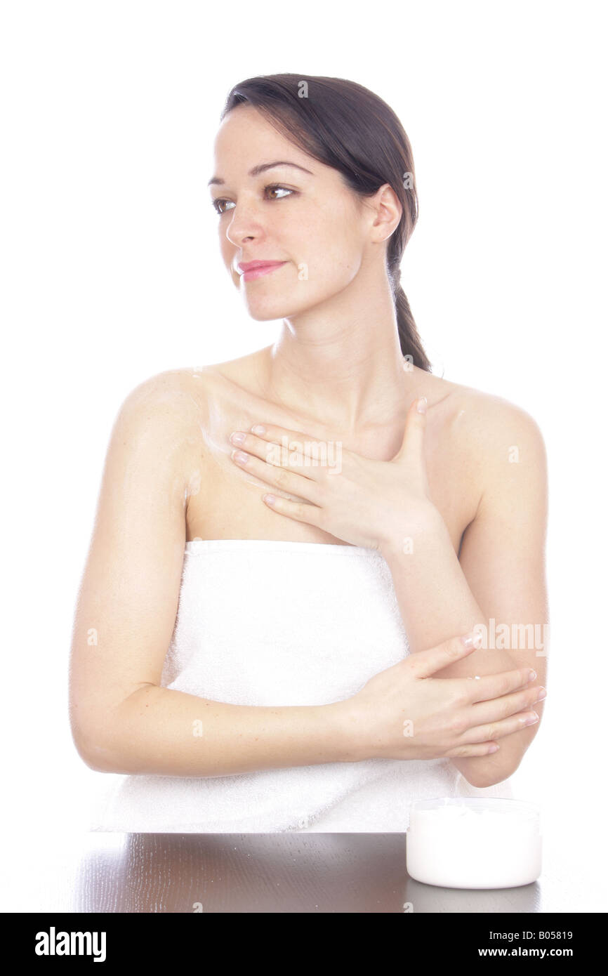 Young Woman Applying Moisturising Skin Body Cream Isolated Against A ...