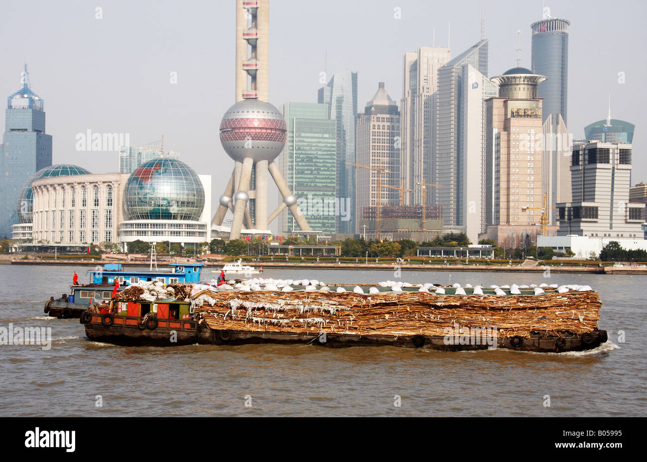 BUSY SHIPPING LANE ON HUANGPO RIVER PASSES THE SPECTACULAR MODERN ...