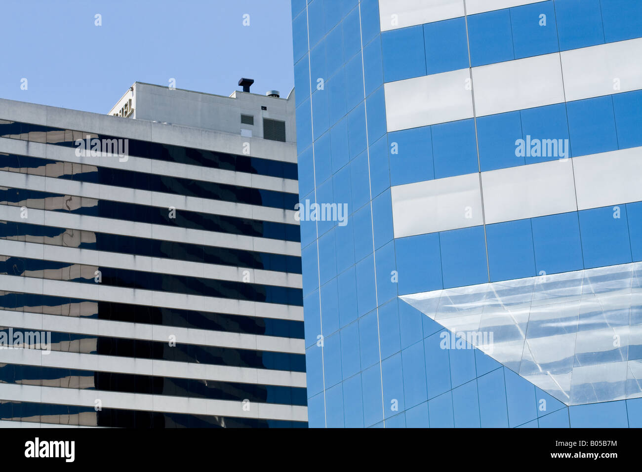 Tall building with mirror windows with another building in the ...