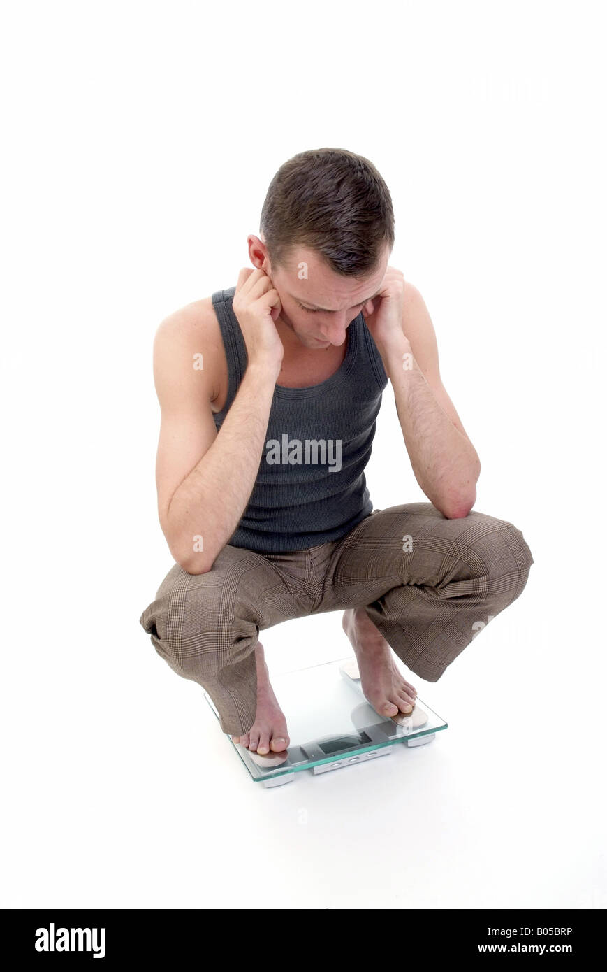 young man on scale Stock Photo - Alamy