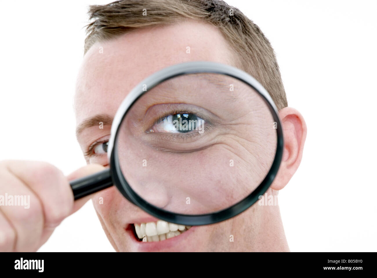 man looking through a loupe Stock Photo - Alamy