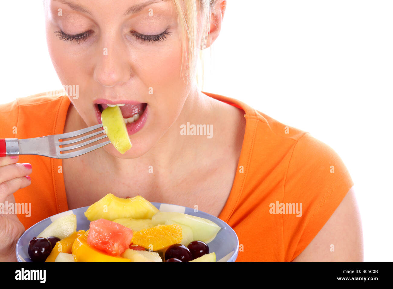 Young Woman Eating And Enjoying A Fresh Sweet Mixed Summer Fruit Salad ...