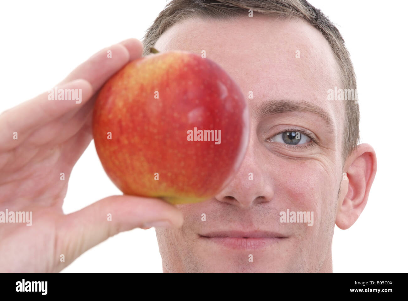 young man with an apple Stock Photo - Alamy