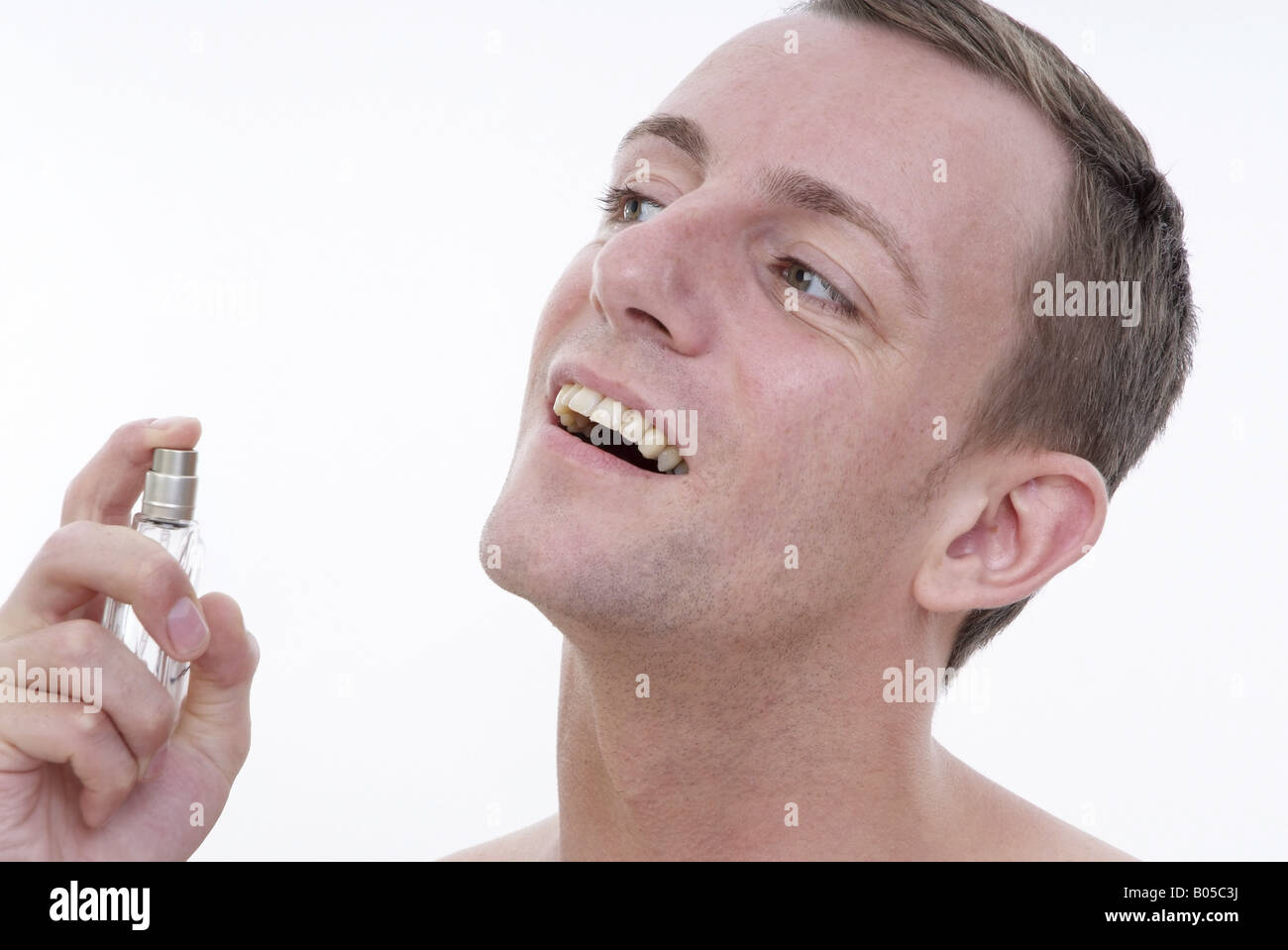 young man uses perfume Stock Photo - Alamy