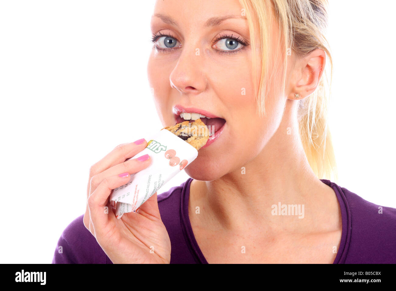 Young Woman Eating Oatmeal and Raisin Cookie Model Released Stock Photo ...