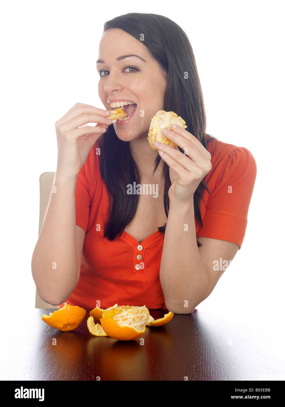 Young Woman Peeling and Eating an Orange Model Released Stock Photo - Alamy