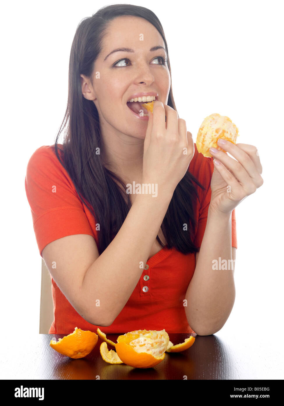 Young Woman Peeling and Eating an Orange Model Released Stock Photo - Alamy