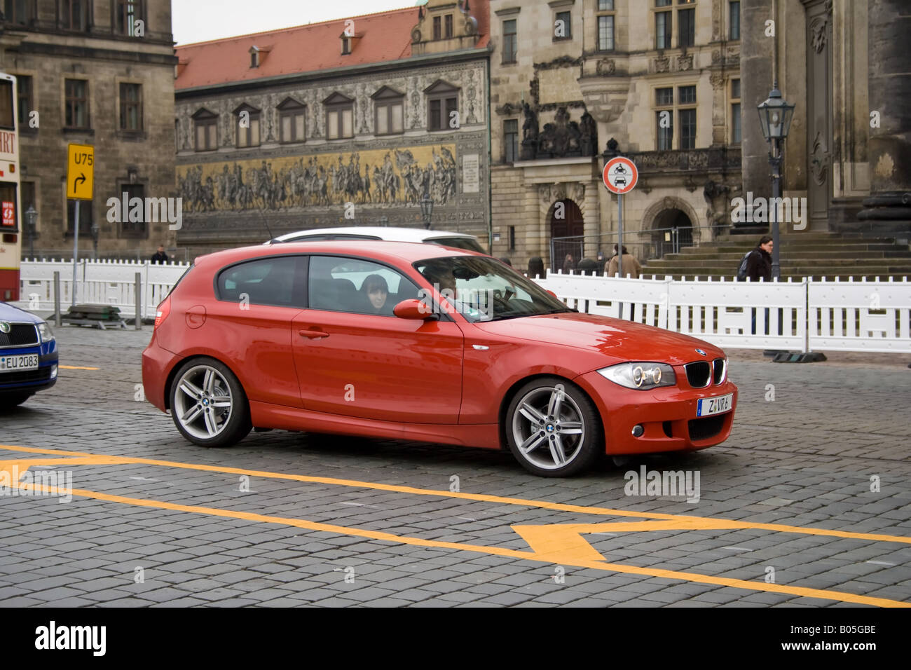 A red BMW 1 Series hatchback parked on a cobblestone street in Dresden ...