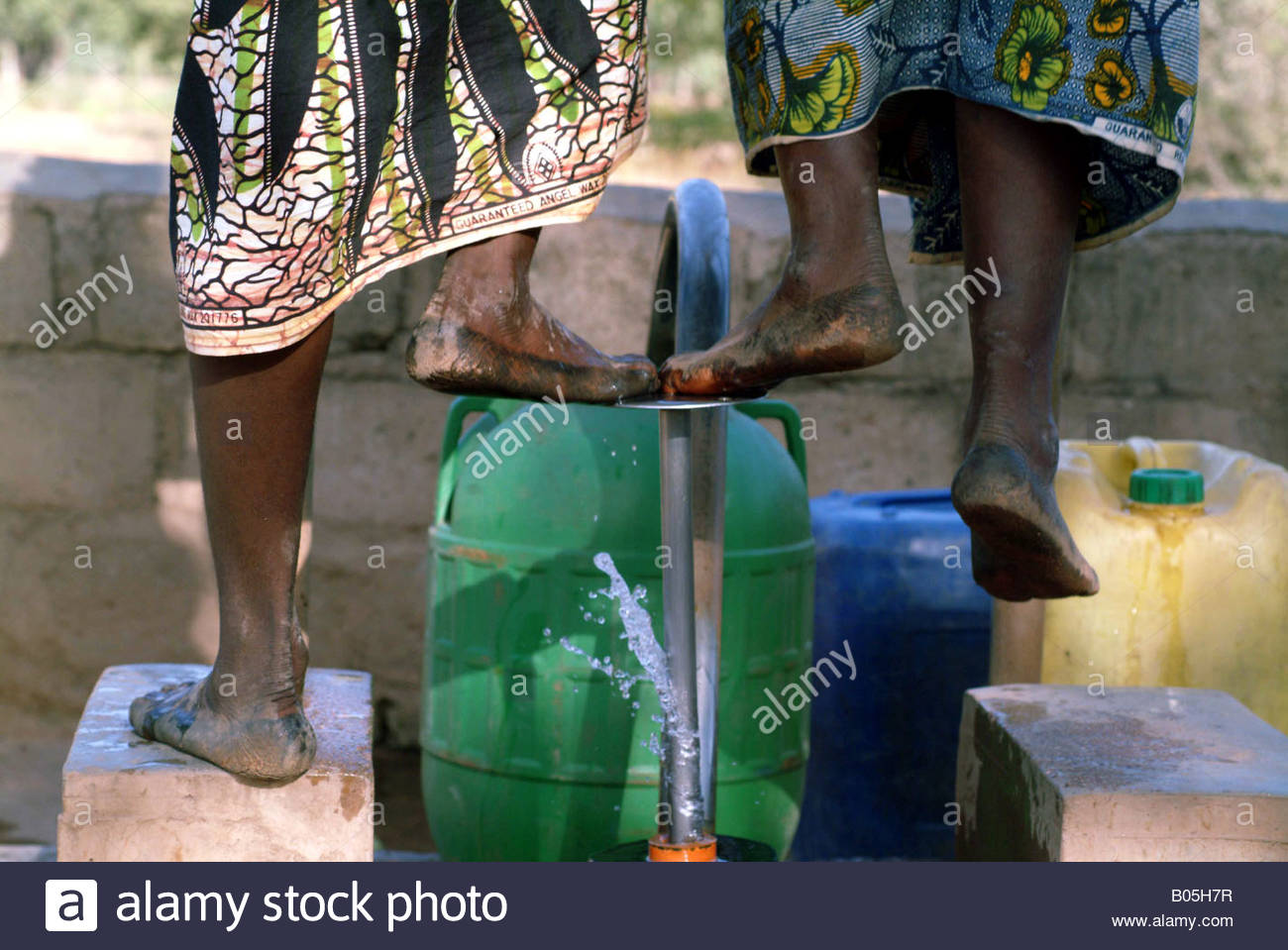 Portrait of a bare feet girl drinking glass of milk on stairs Stock ...