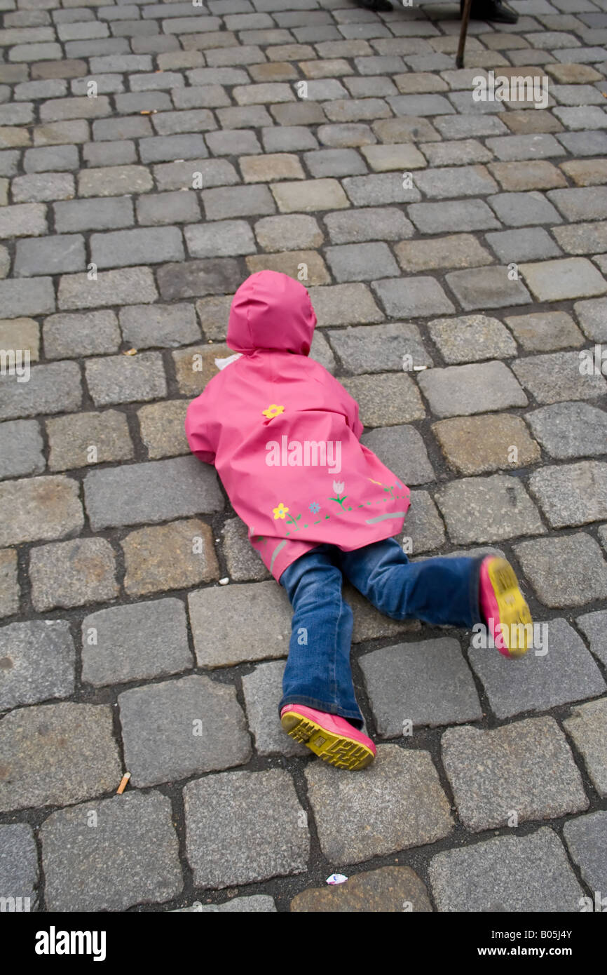 child lying on the ground Stock Photo - Alamy