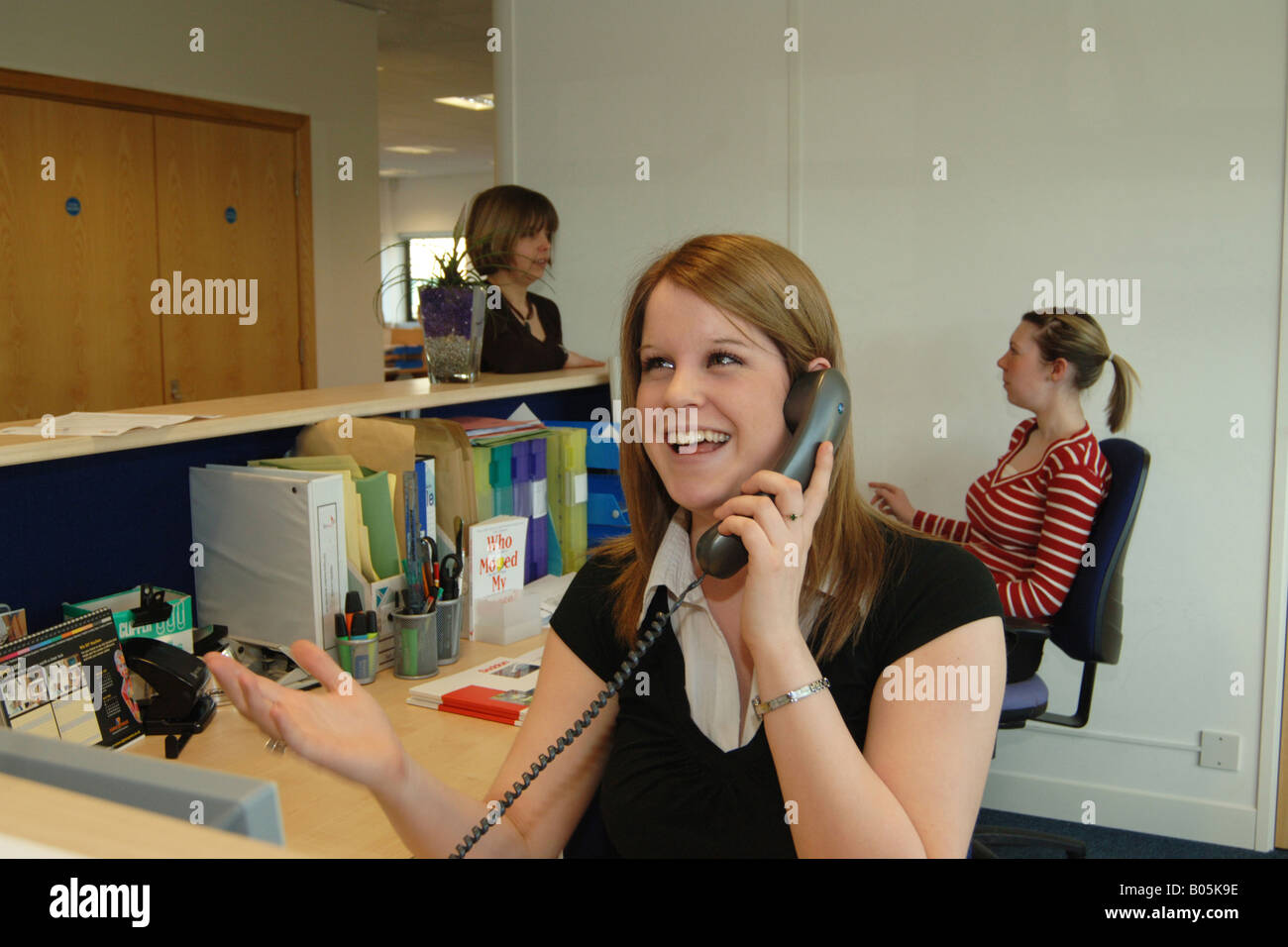 Office Receptionist works at an office Stock Photo - Alamy