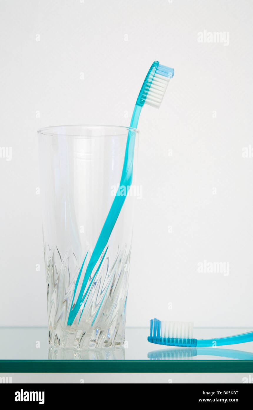 Two toothbrushes One in a glass one on the shelf Stock Photo - Alamy Two toothbrushes One in a glass one on the shelf Stock Photo - Alamy