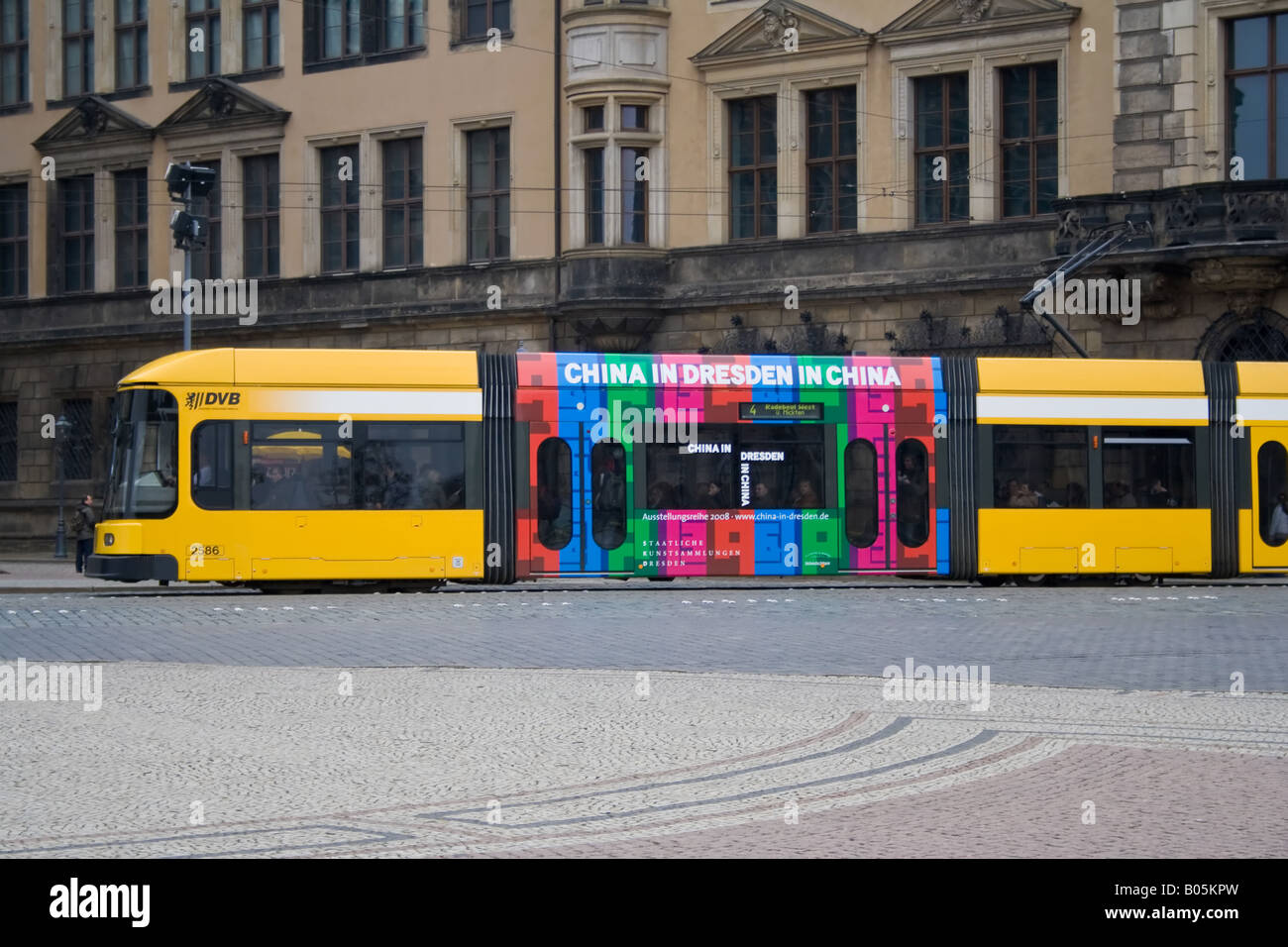 A colorful yellow tram with an advertisement for "China in Dresden ...
